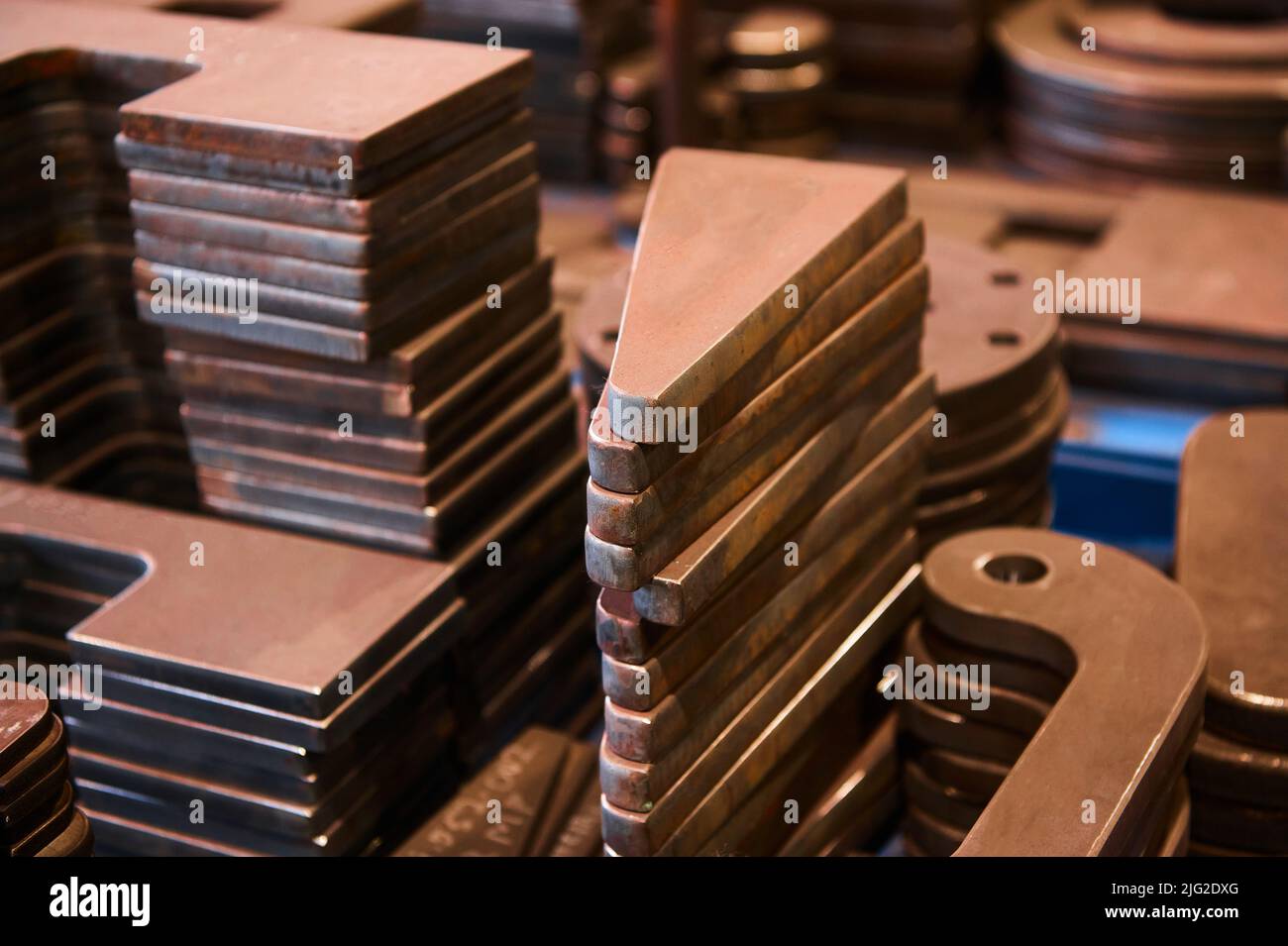 Piles of different workpieces made of metal material sheet Stock Photo ...