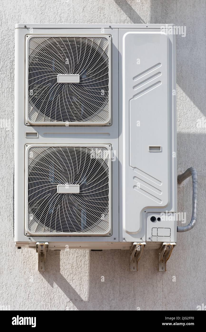 outdoor air conditioner unit with heat exchanger hanging outside the ...