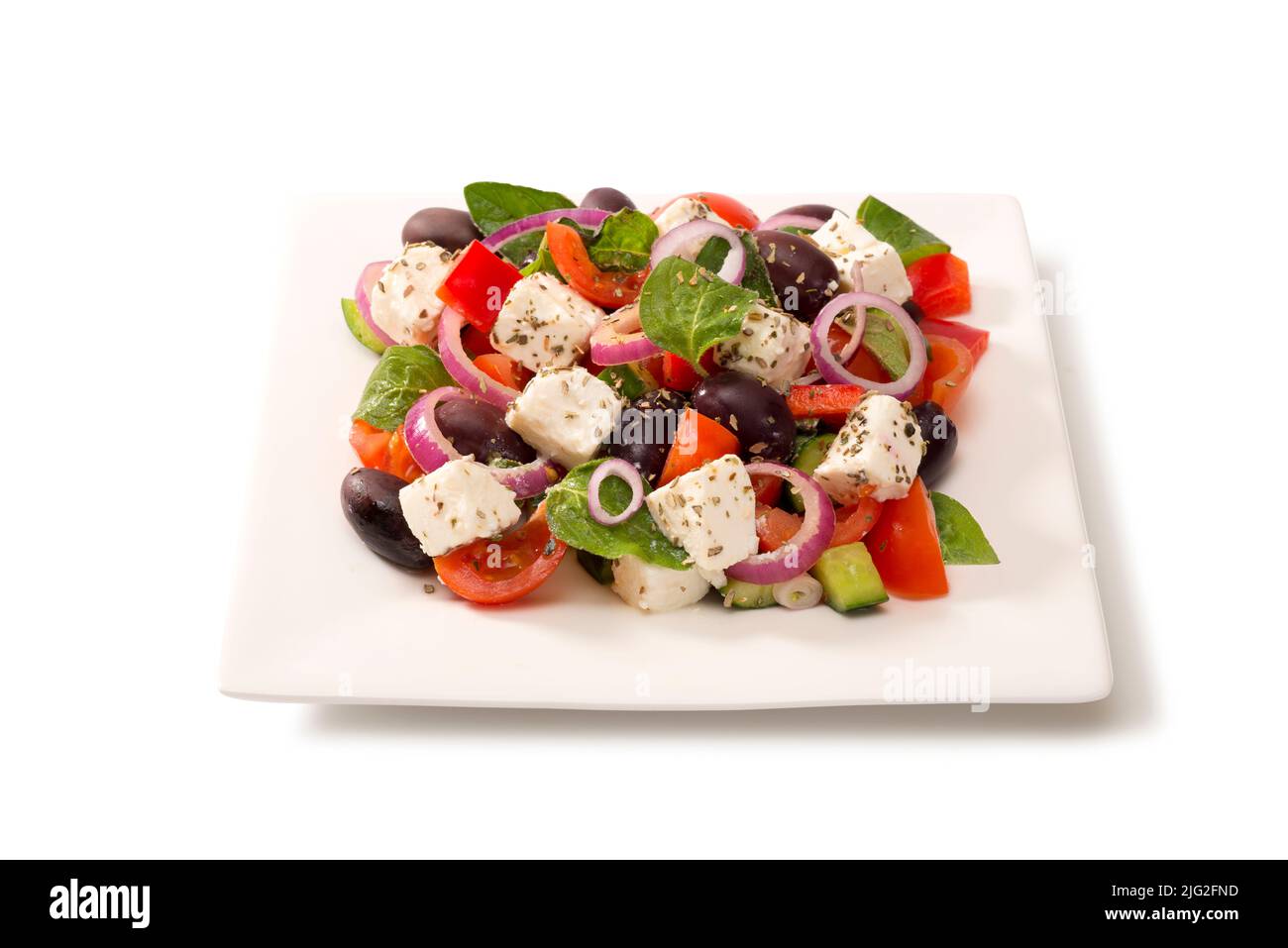 Greek salad in a square plate isolated on white Stock Photo - Alamy