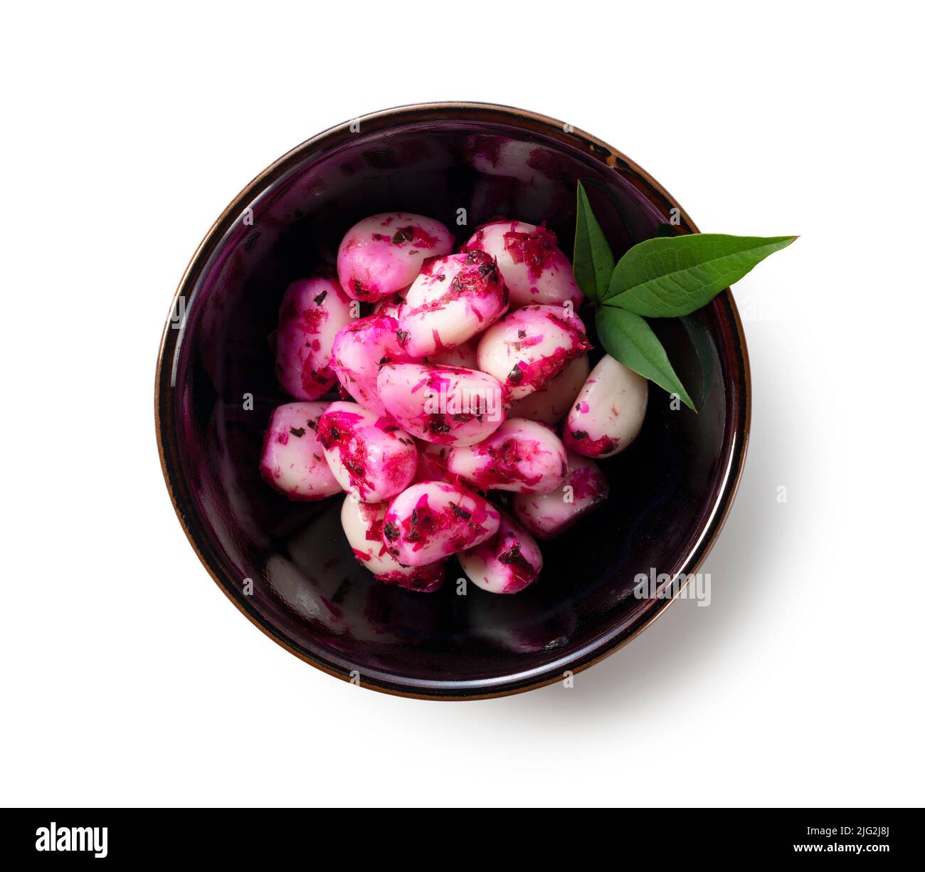 Pickled shiso bonito garlic on a plate placed on a white background ...