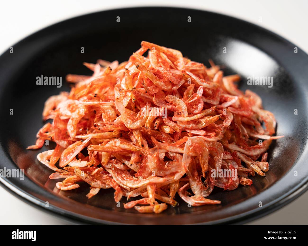 Dried sakura shrimps on a plate placed on a white background. Image of ...