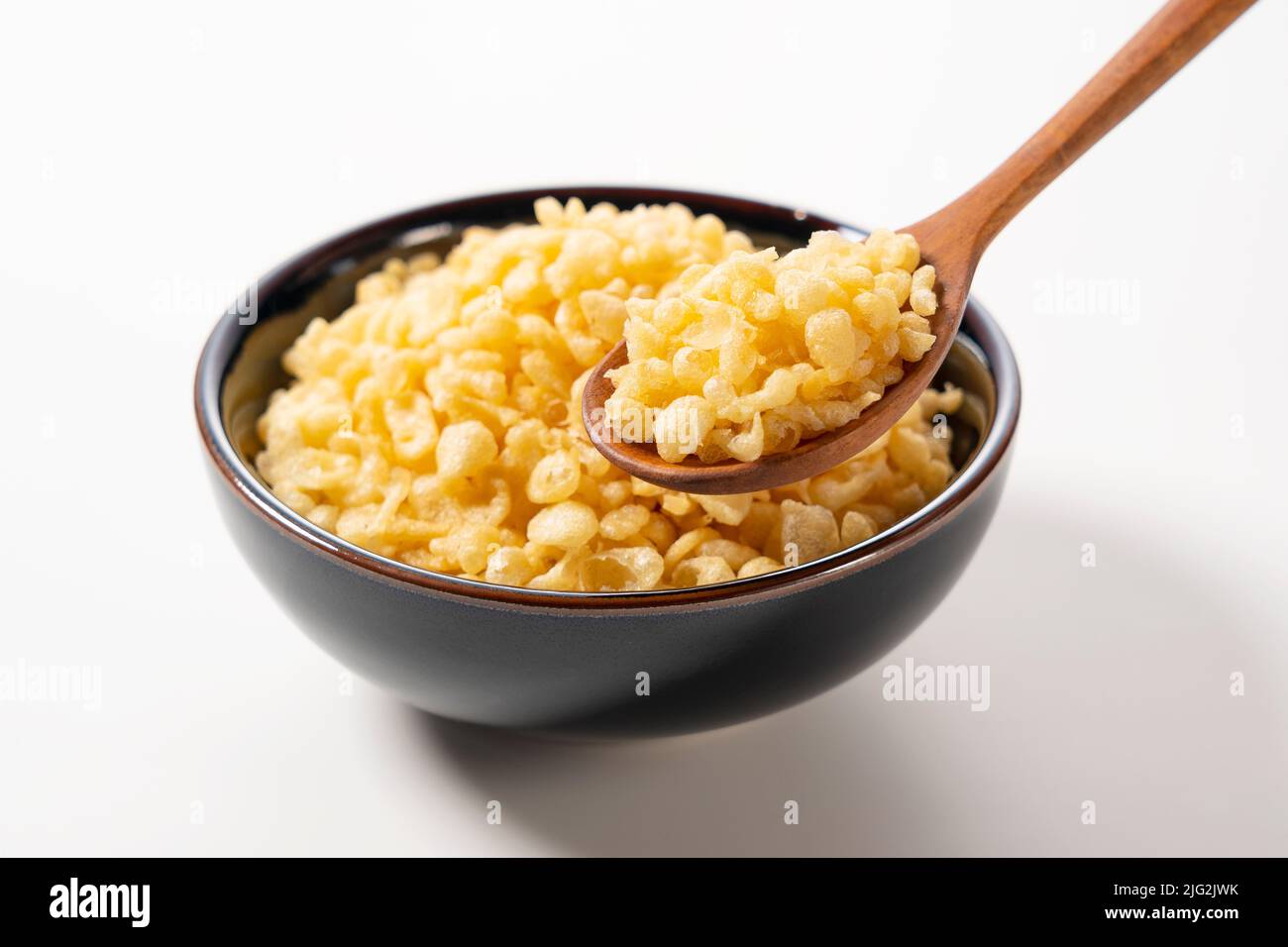Tenkasu served in a bowl placed on a white background. An image of ...
