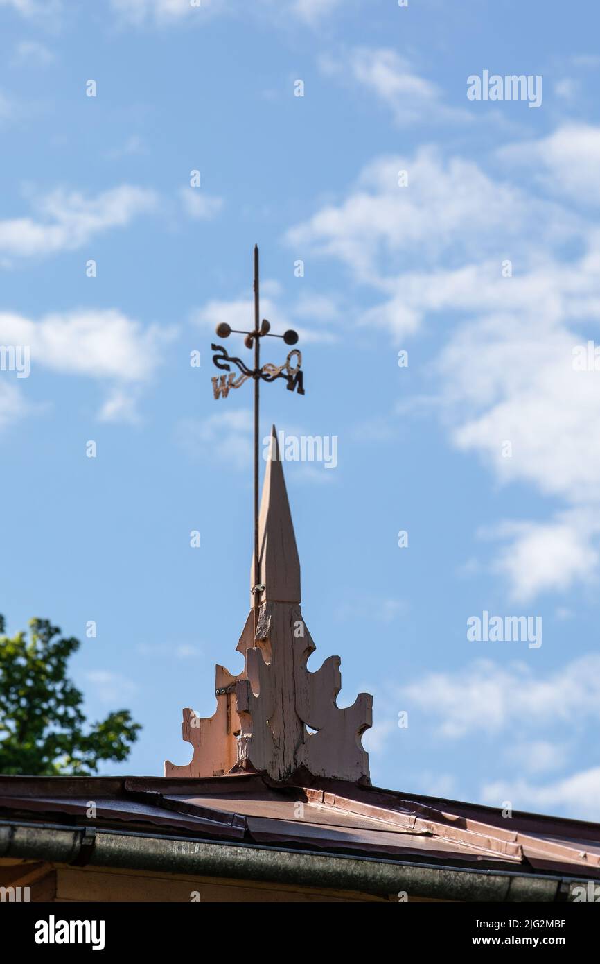 An old design wind indicator on the roof of a house Stock Photo - Alamy