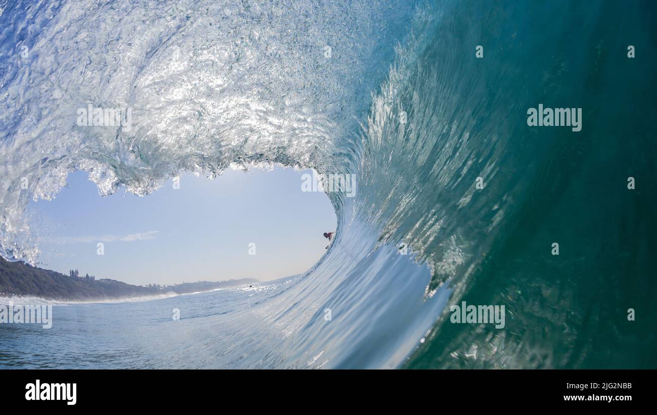Surfing ride inside hollow wave swimming close-up water photo of scenic ...