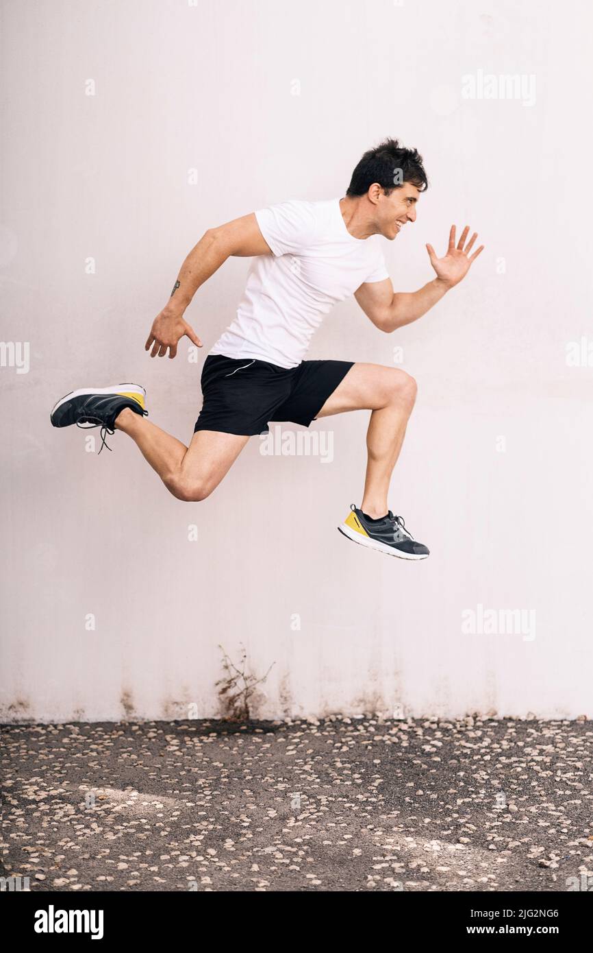 Isolated male athlete jumping outdoors Stock Photo - Alamy
