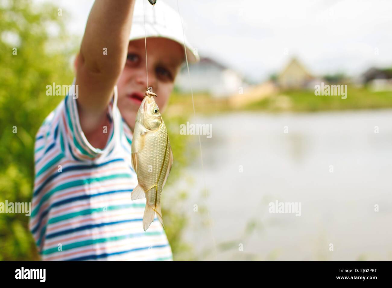 Boy caught a fish. child on the lake fishing Stock Photo - Alamy
