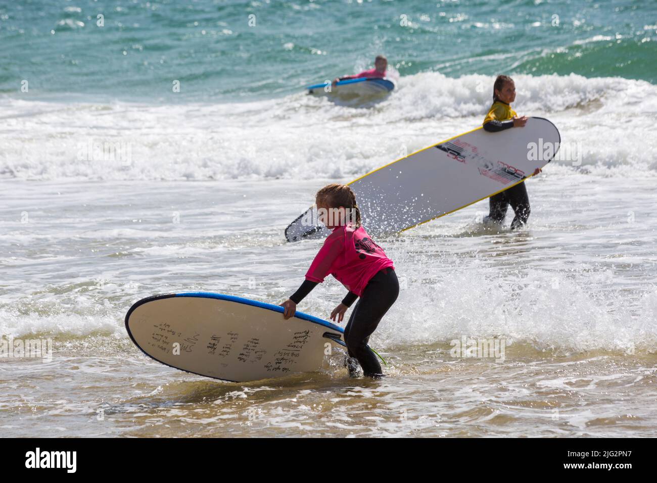 Children playing on body boards in the sea at Boscombe, Bournemouth ...