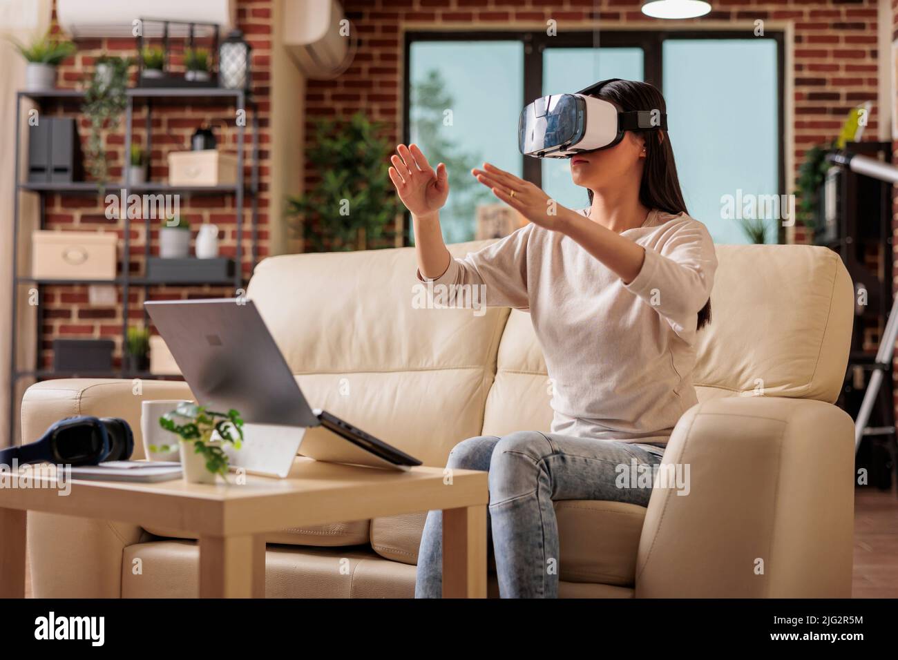 Happy asian woman enjoying wearing VR virtual reality headset, modern ...