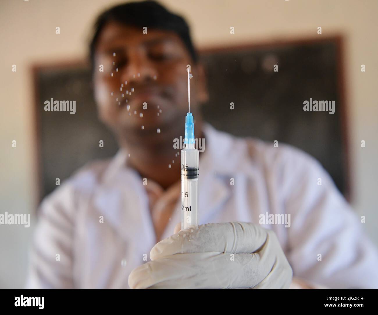 A medical worker prepares to inoculate a school student with the ...