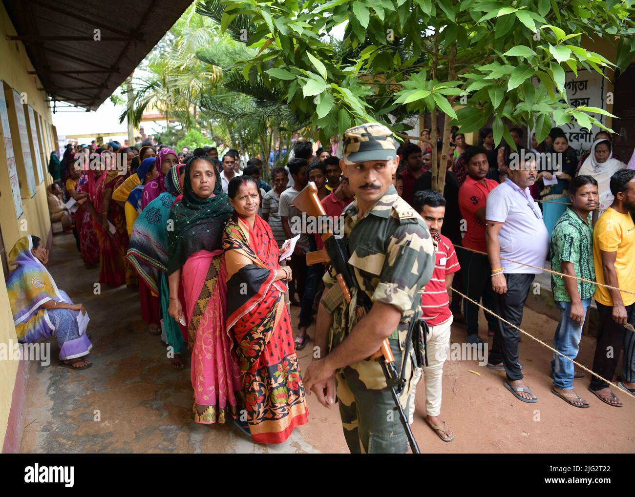 Election staff members with an electronic voting machine (EVM) during ...