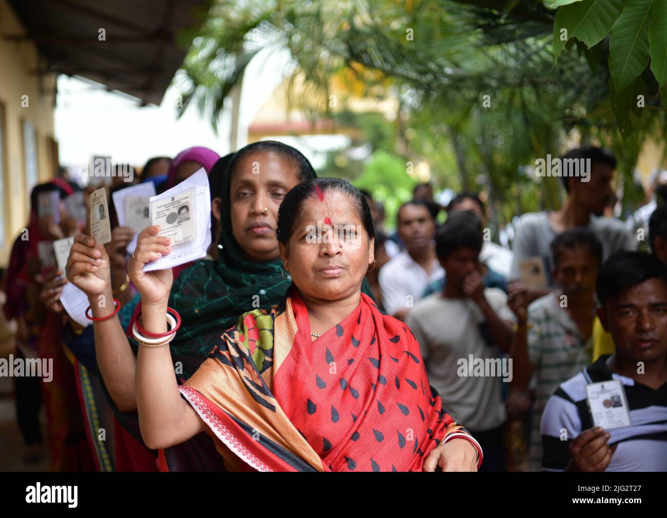 Election staff members with an electronic voting machine (EVM) during ...