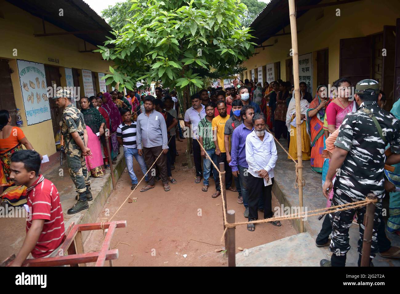 Election staff members with an electronic voting machine (EVM) during ...