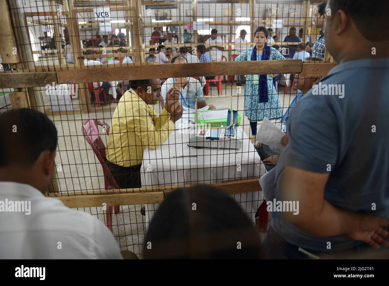 Election staff members with an electronic voting machine (EVM) during ...