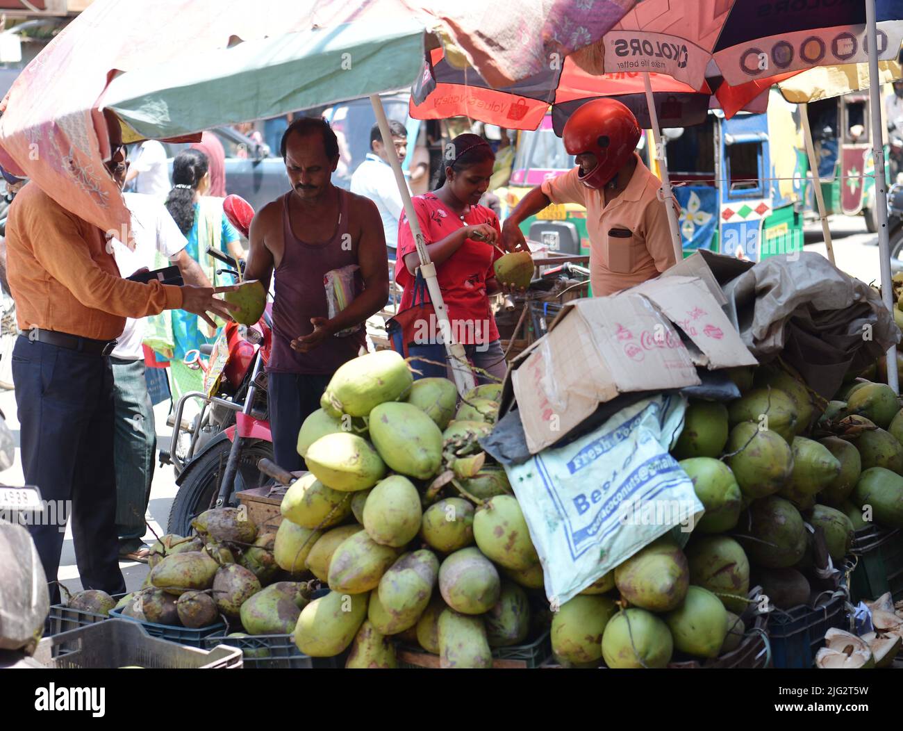 Coconut vendor cuts coconuts hi-res stock photography and images - Alamy