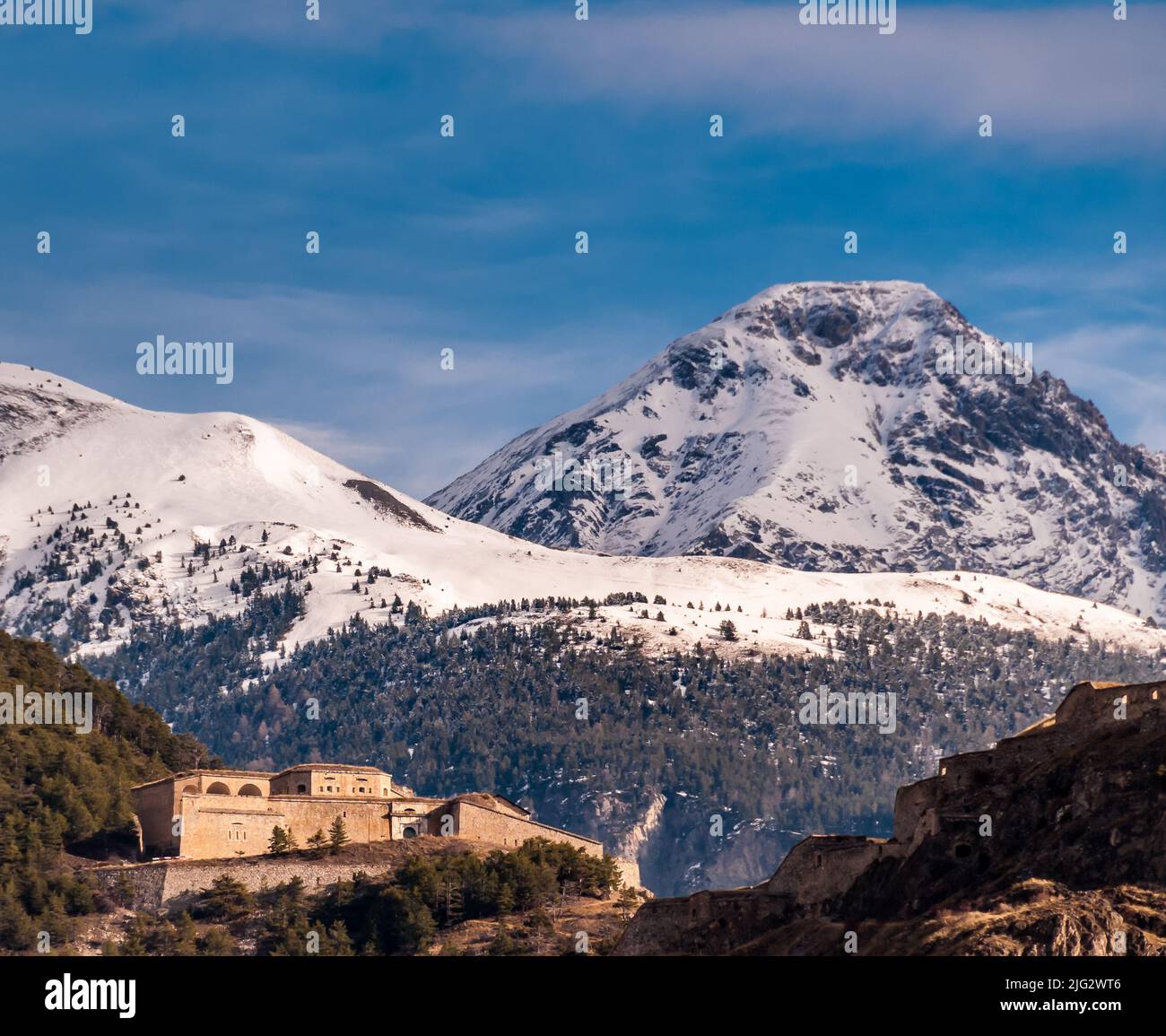 View of fort from Briançon with snow covered mountains in the distance ...