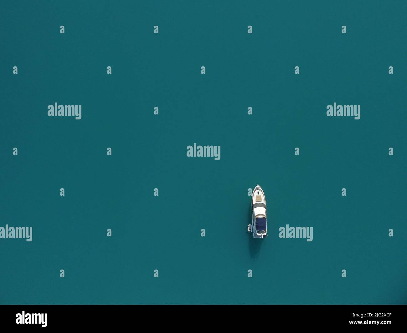 Aerial yacht on calm sea. Luxury cruise trip. View from above of white ...
