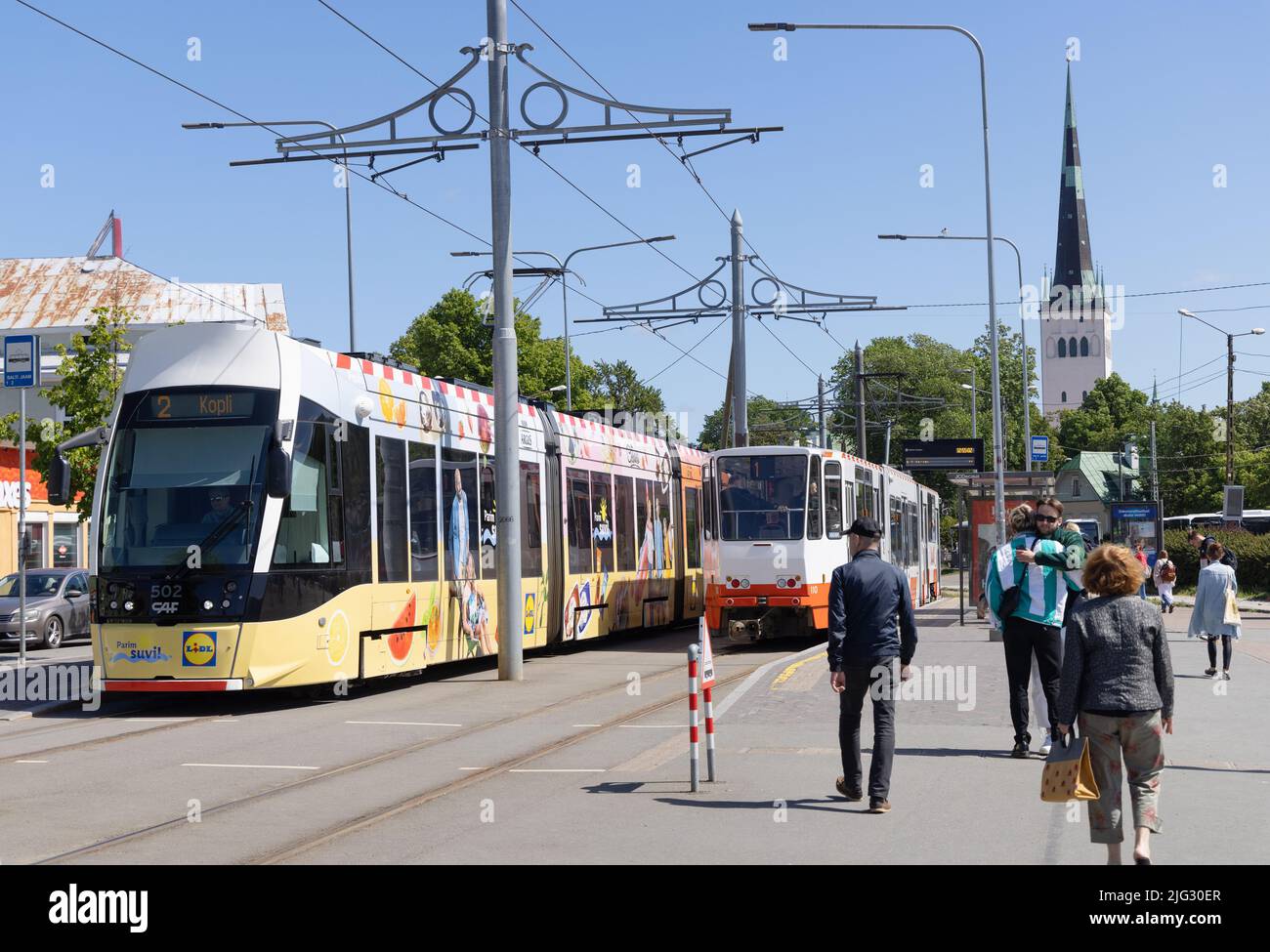 Tallinn tram - trams forming part of the public transport system, St Olafs church in the ...
