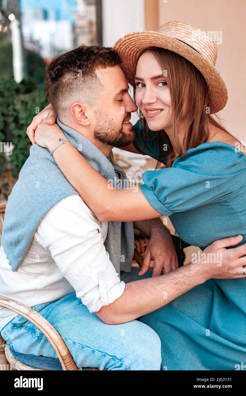 Beautiful loving couple sitting in outdoor cafe Stock Photo - Alamy
