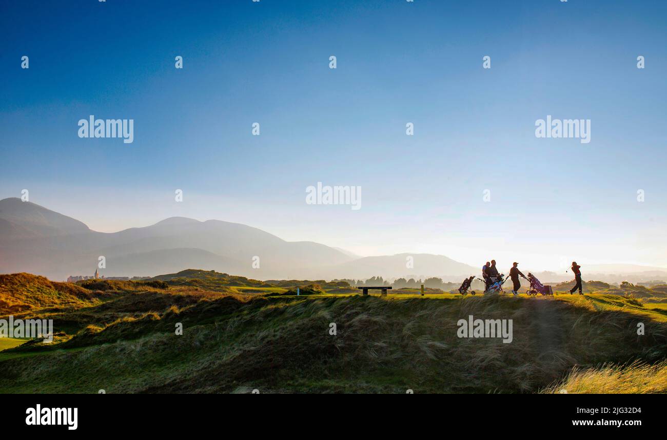 The setting sun lights up the Royal County Down Links under the ...