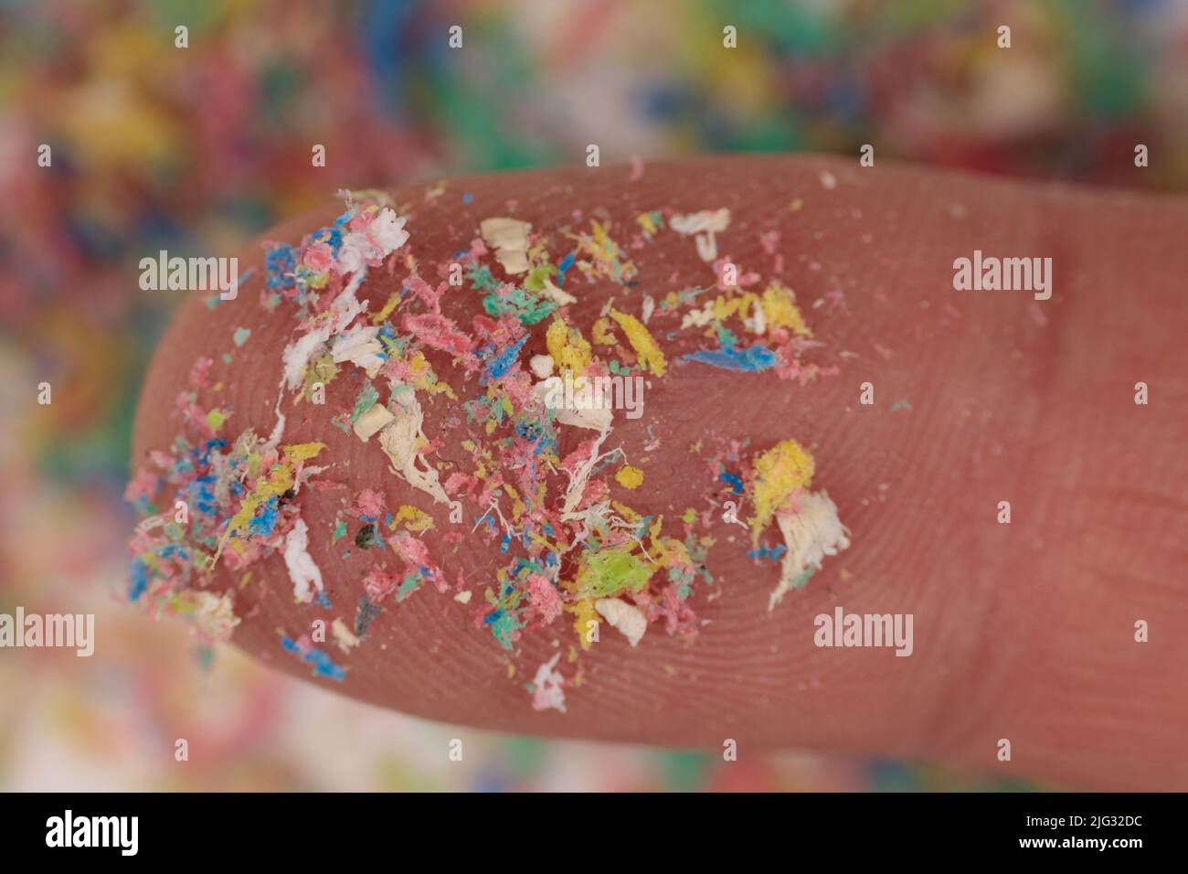 Close-up shot of microplastics on human fingers. Creative concept of ...