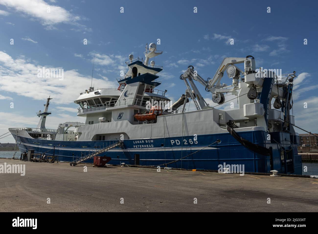 A blue fishing boat moored in Peterhead Harbour Stock Photo - Alamy