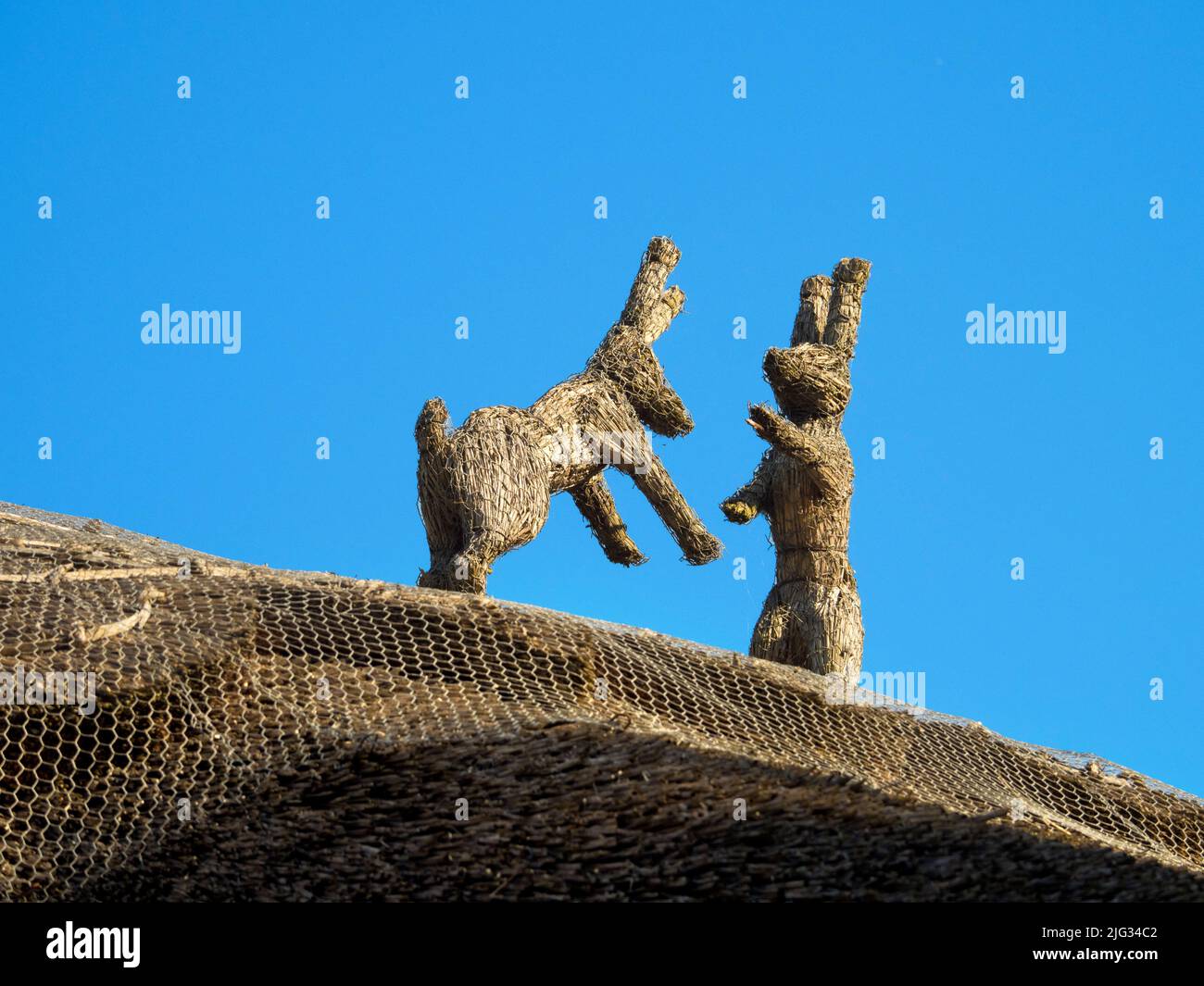 The carving of straw animals on thatched roof is a traditional style of ...