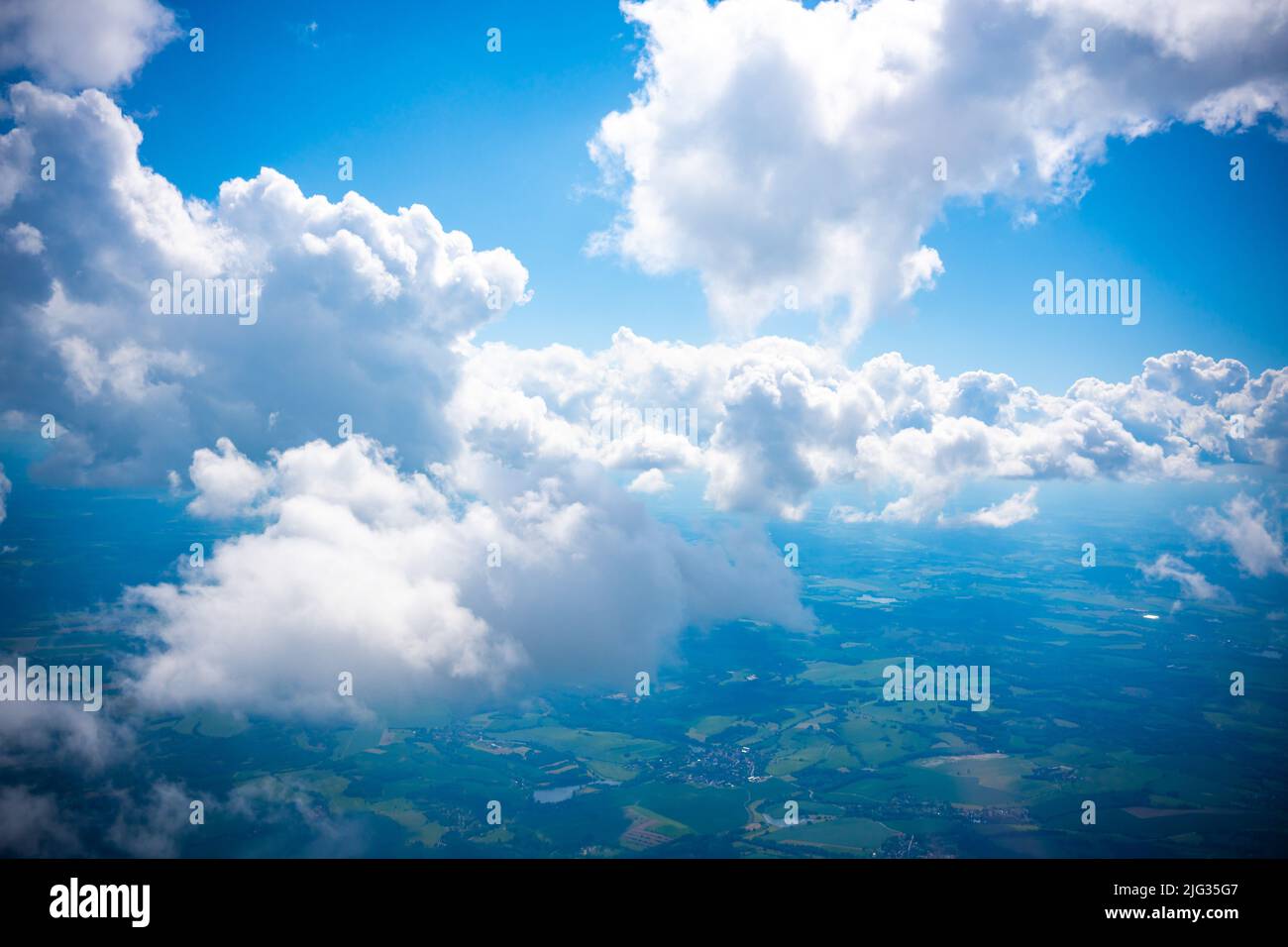 Aerial view scene of rural place which hiding under white fluffy clouds ...