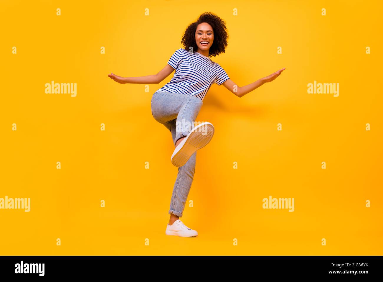 Full body portrait of excited crazy girl raise leg footwear sole ...