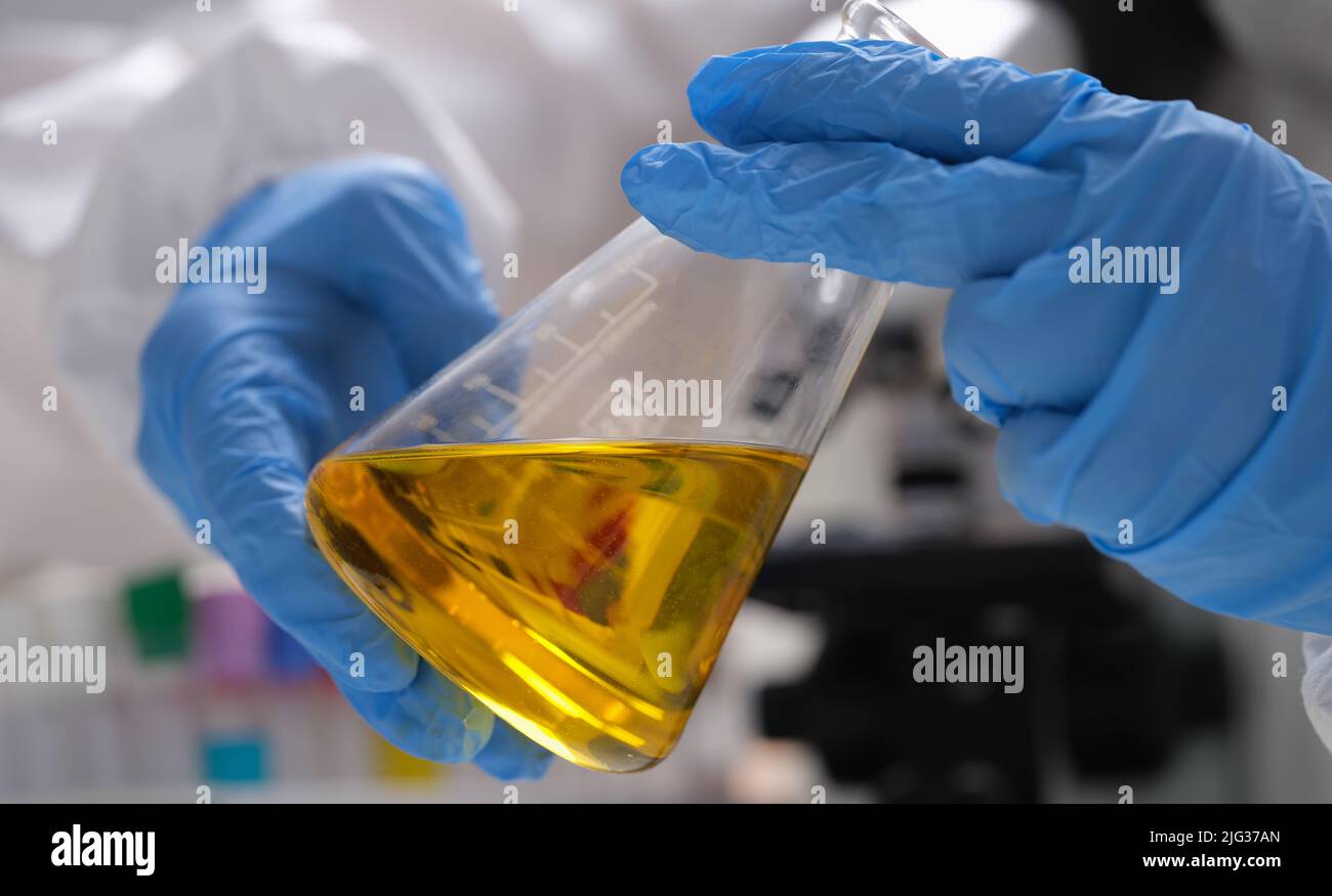 Hand drawn scientist holding laboratory glassware with golden oil ...