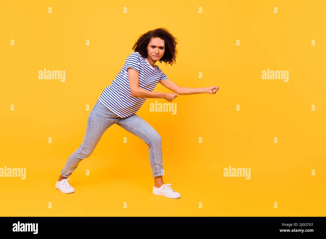 Full body profile portrait of determined young lady arms pull empty ...
