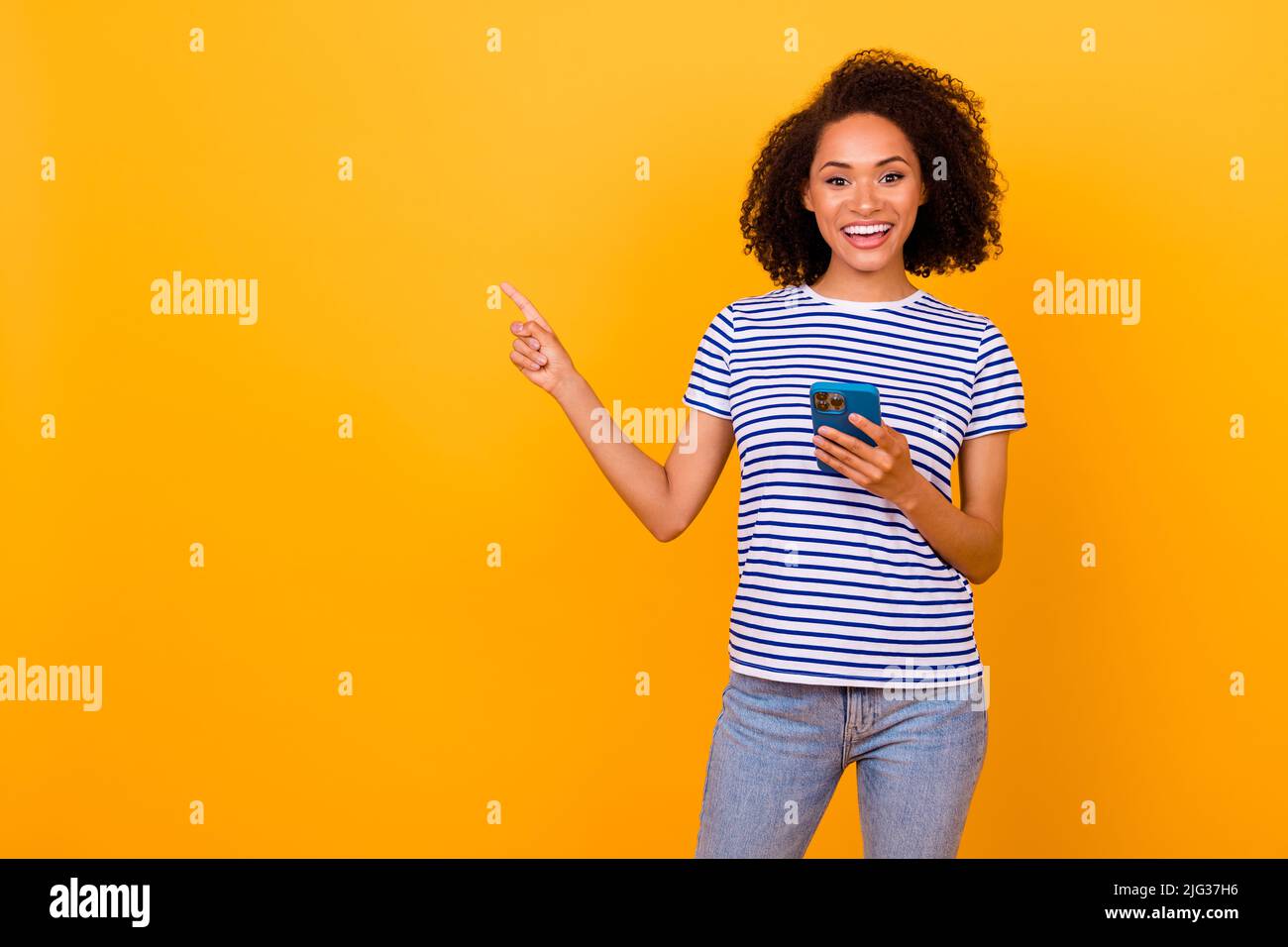 Photo of shiny sweet girl dressed striped t-shirt reading modern gadget ...