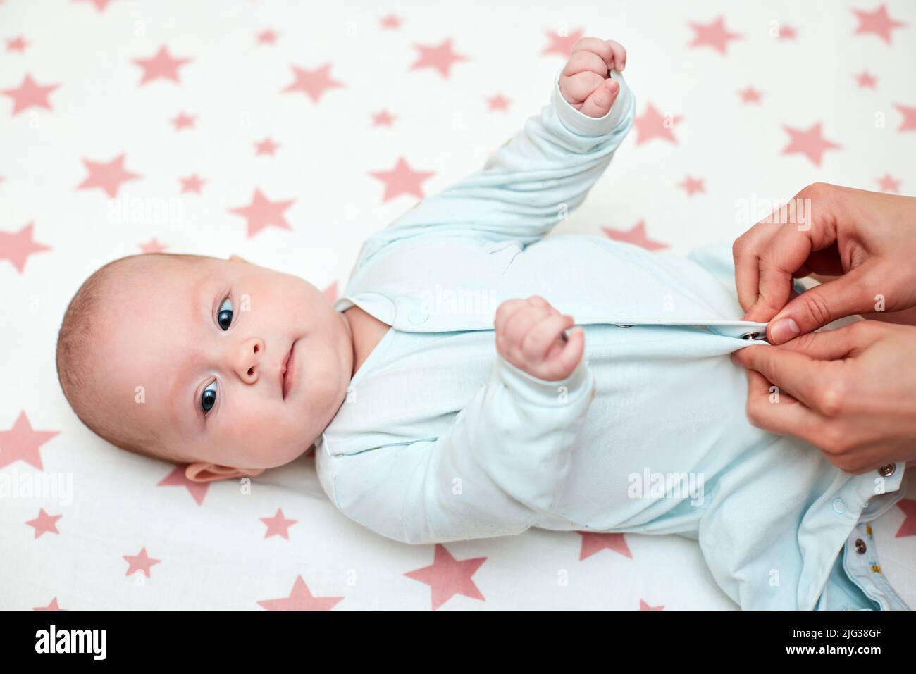 Mom dressing baby hi-res stock photography and images - Alamy