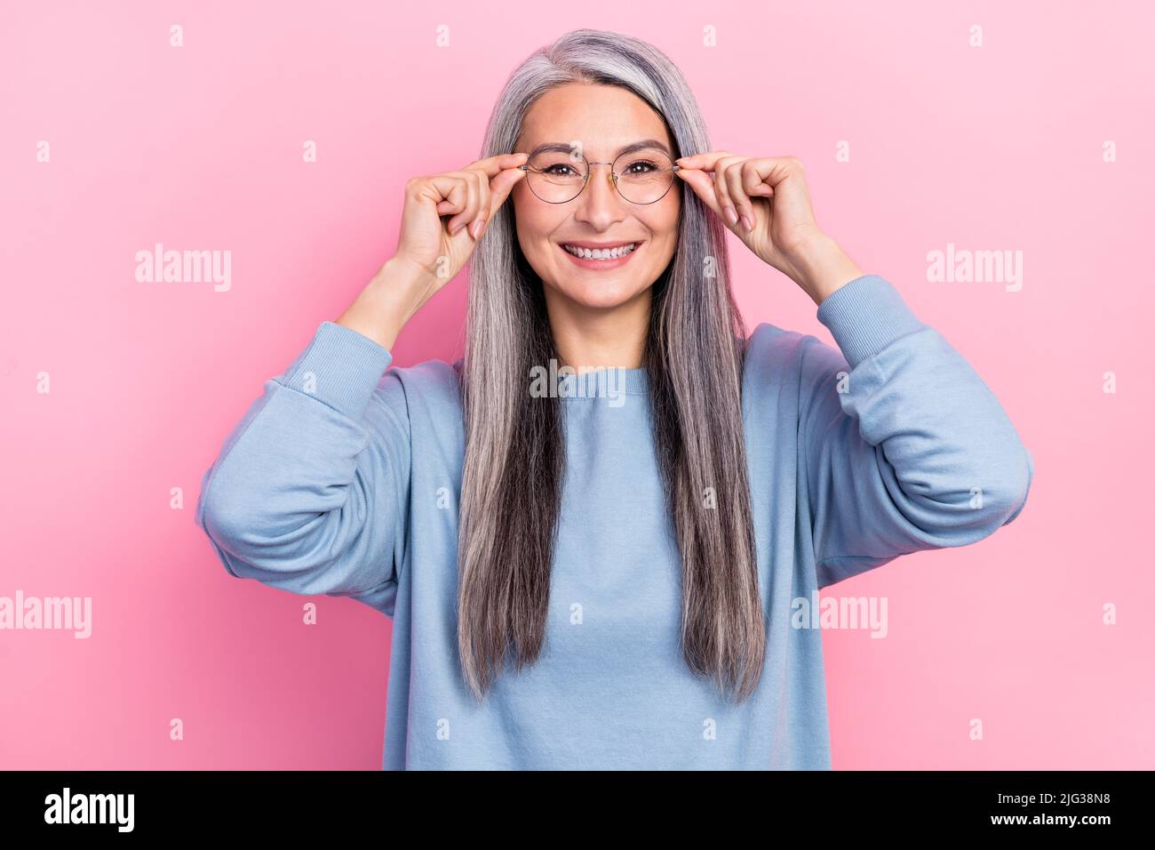 Photo of pretty sweet retired woman blue sweater arms spectacles ...