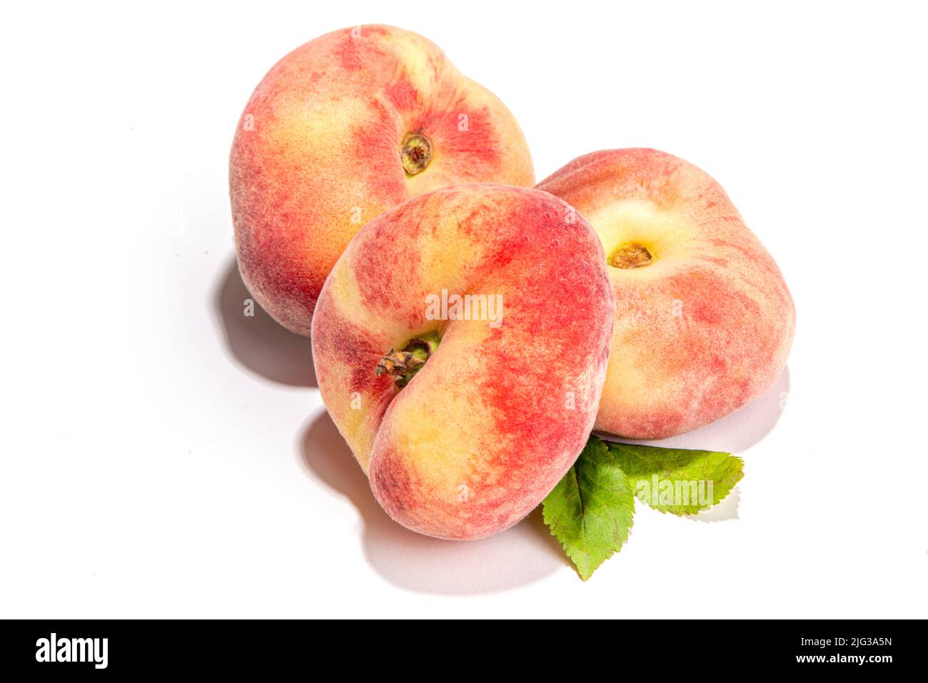 Ripe organic chinese flat fig peach, whole and slices, with leaves ...
