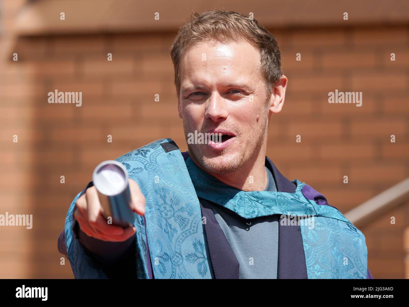Outlander actor Sam Heughan with his honorary doctorate after receiving ...