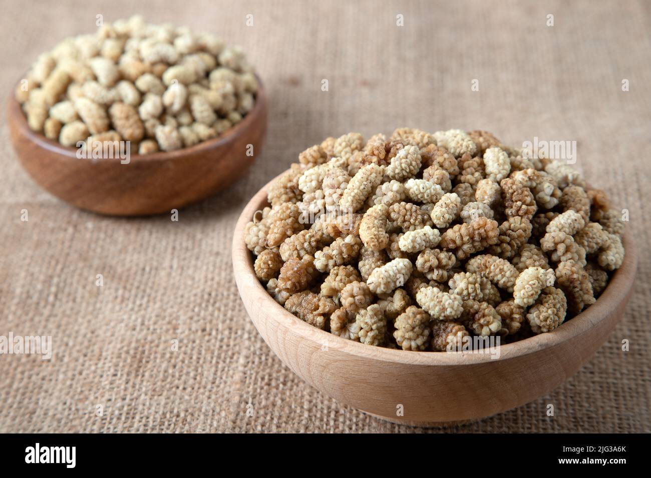 Two Bowl full of dried mulberry on a fabric background Stock Photo - Alamy