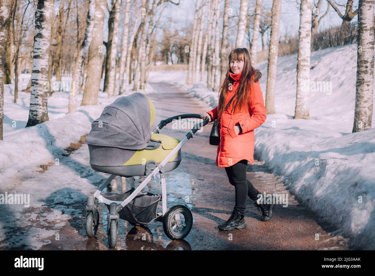 Mom on a walk with a stroller lifestyle. An article about choosing a ...
