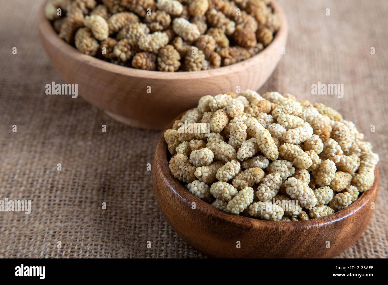 Two Bowl full of dried mulberry on a fabric background Stock Photo - Alamy