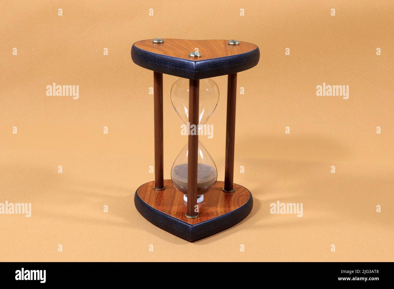 wooden hourglass on colored background Stock Photo - Alamy