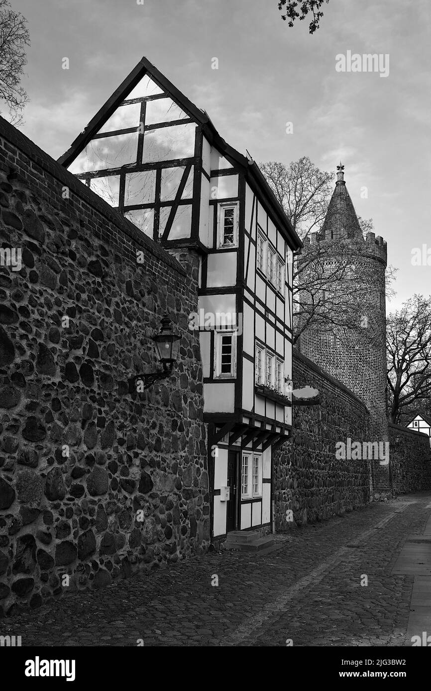 Stone, medieval walls with a historic tower of a two-story house in the ...