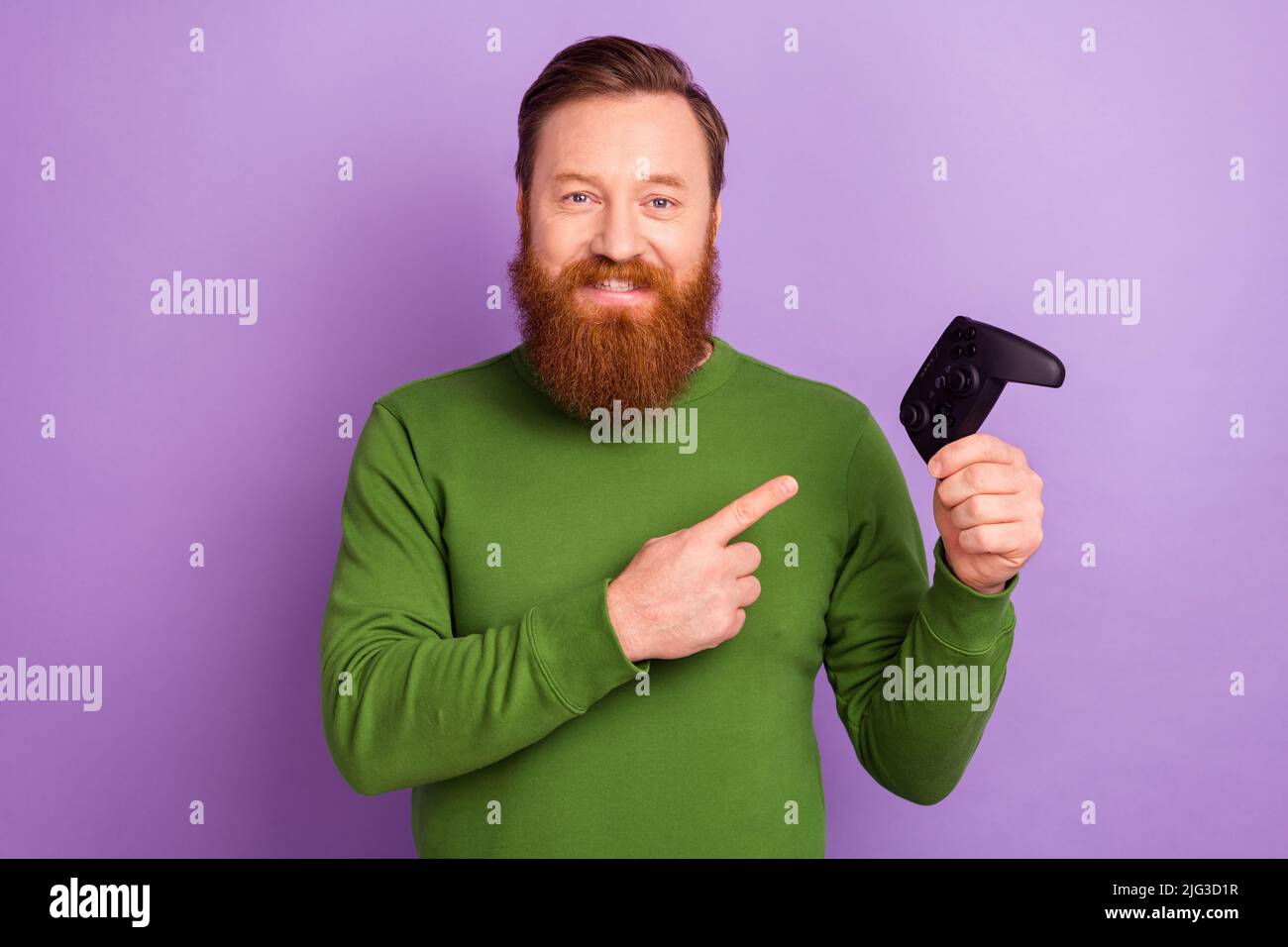 Photo of positive handsome foxy guy promote new playstation joystick ...