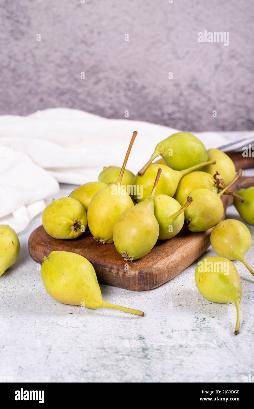 Fresh pear. Ripe pears in a wooden serving dish on a stone background ...