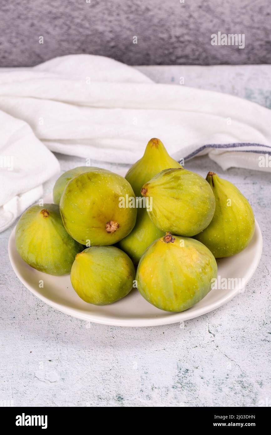 Fresh figs. Ripe figs in plate on stone background. Bulk figs. close up ...
