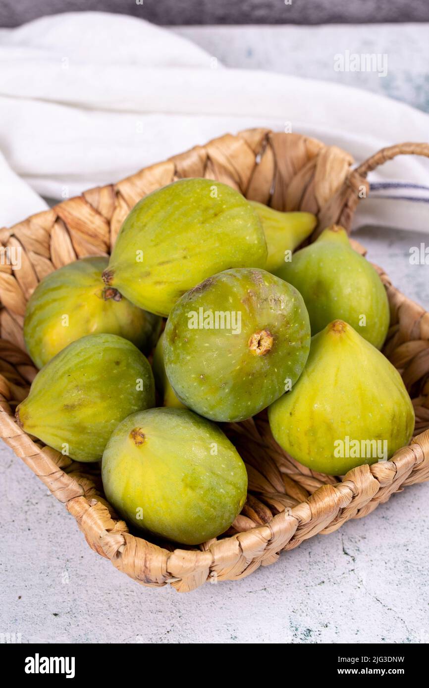 Fresh figs. Ripe figs in a basket on a stone background. Bulk figs ...