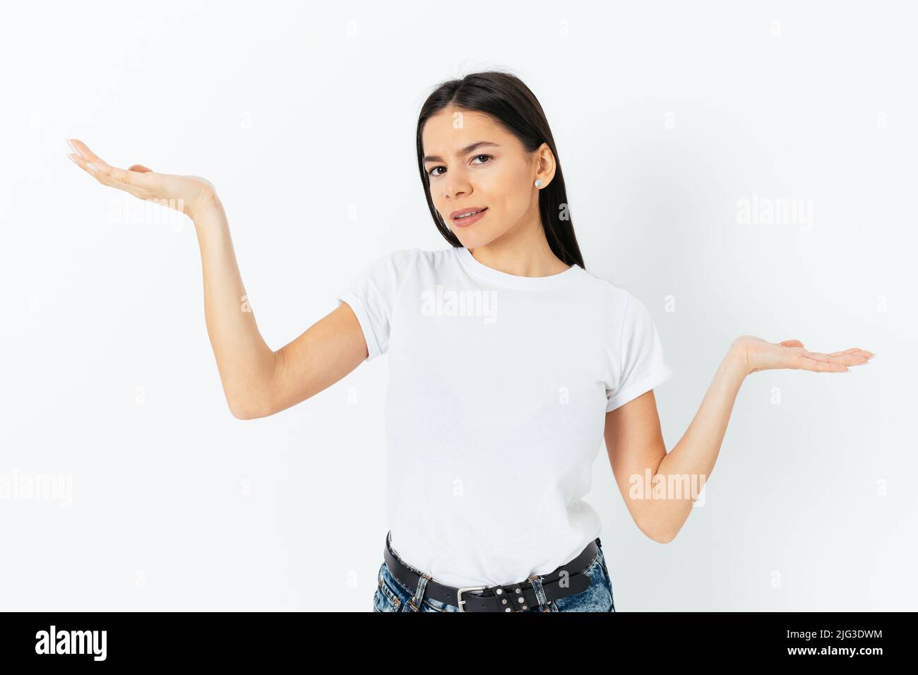 Portrait young woman comparing something, showing empty palms of her ...