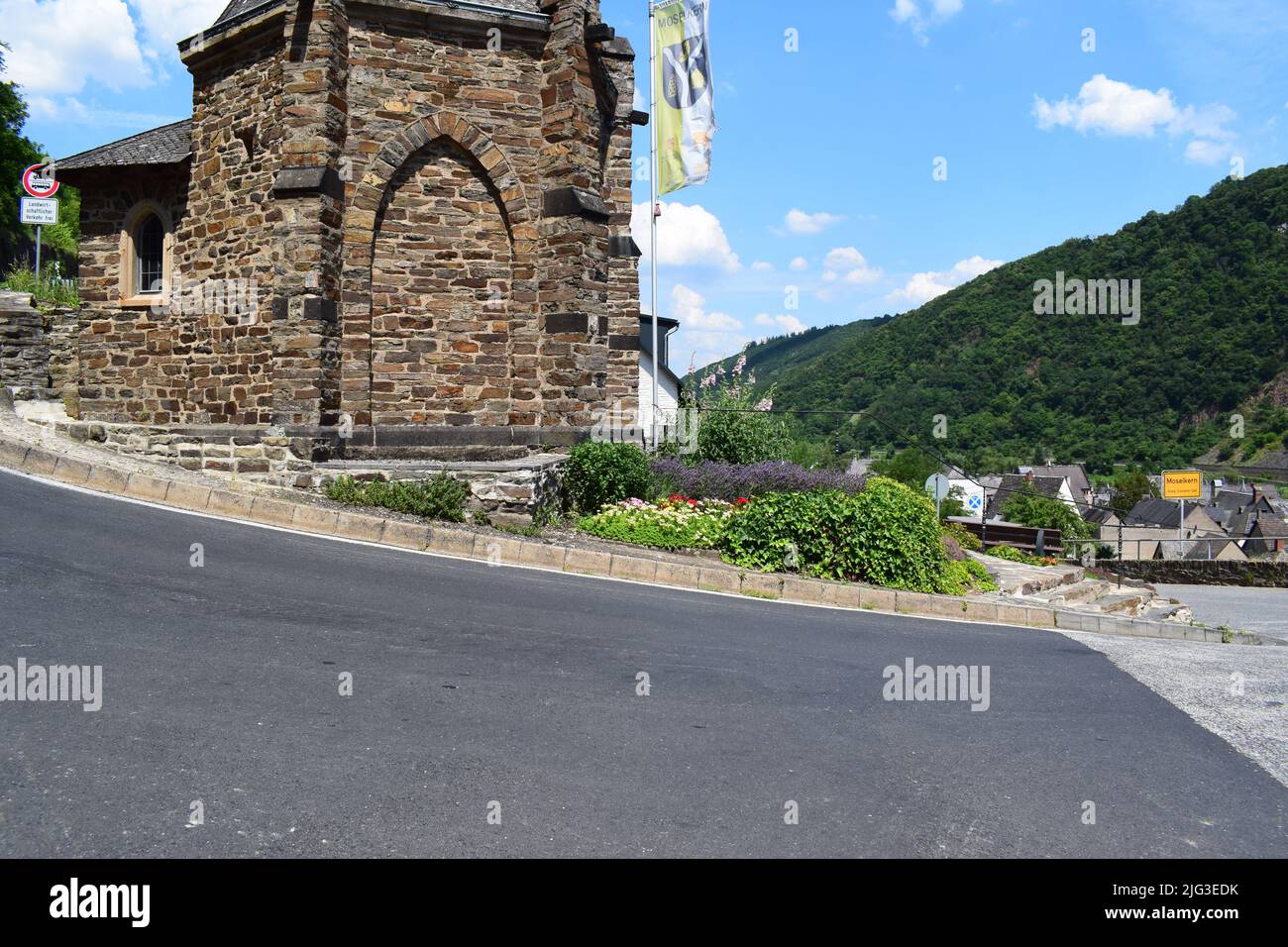 narrow curve road out of Moselkern to the Eifel, curve around a chapel ...