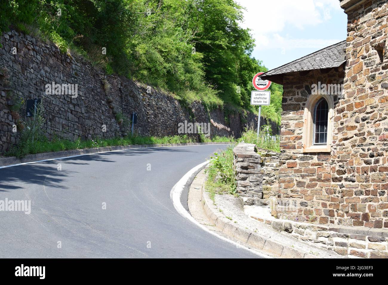 narrow curve road out of Moselkern to the Eifel, curve around a chapel ...