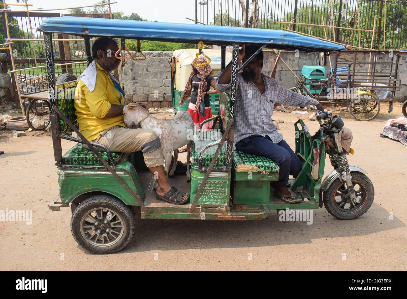 A man takes his goat in an electric rickshaw which he had purchased ...
