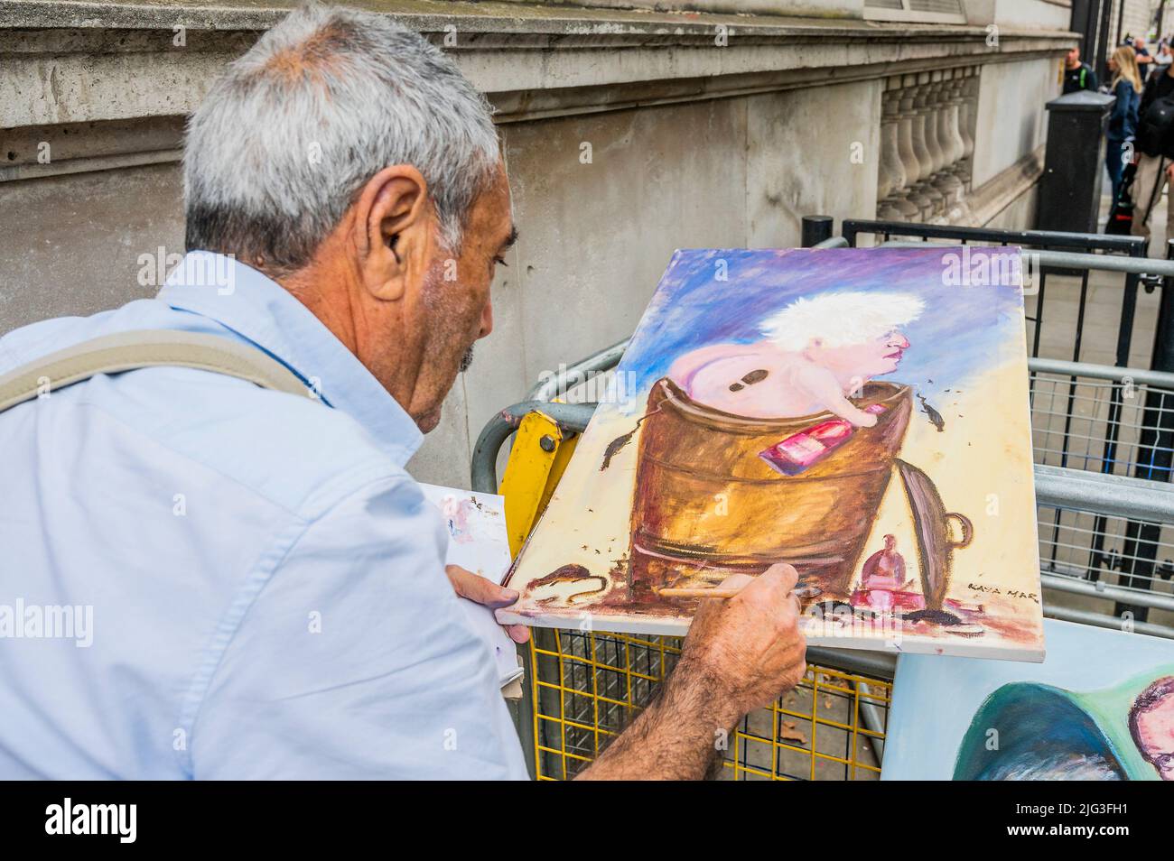 London, UK. 7th July, 2022. Kaya Mar, satirical artist, works on his ...