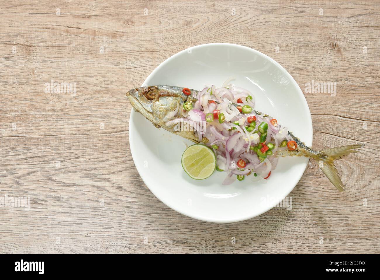 deep fried salty mackerel fish topping chop shallot and chili with ...